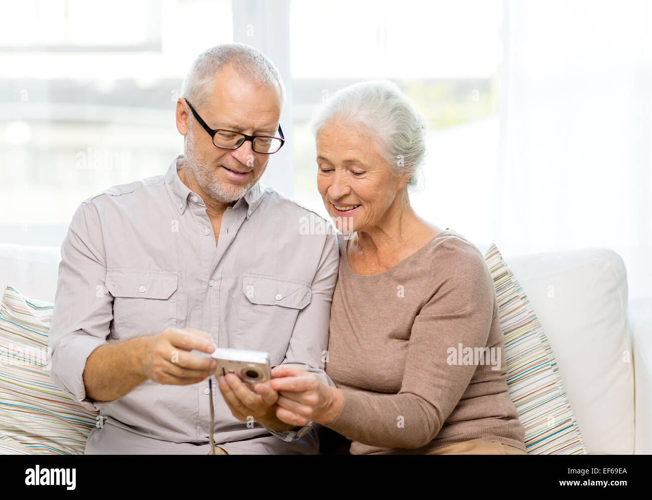 happy senior couple with camera at home Stock Photo - Alamy