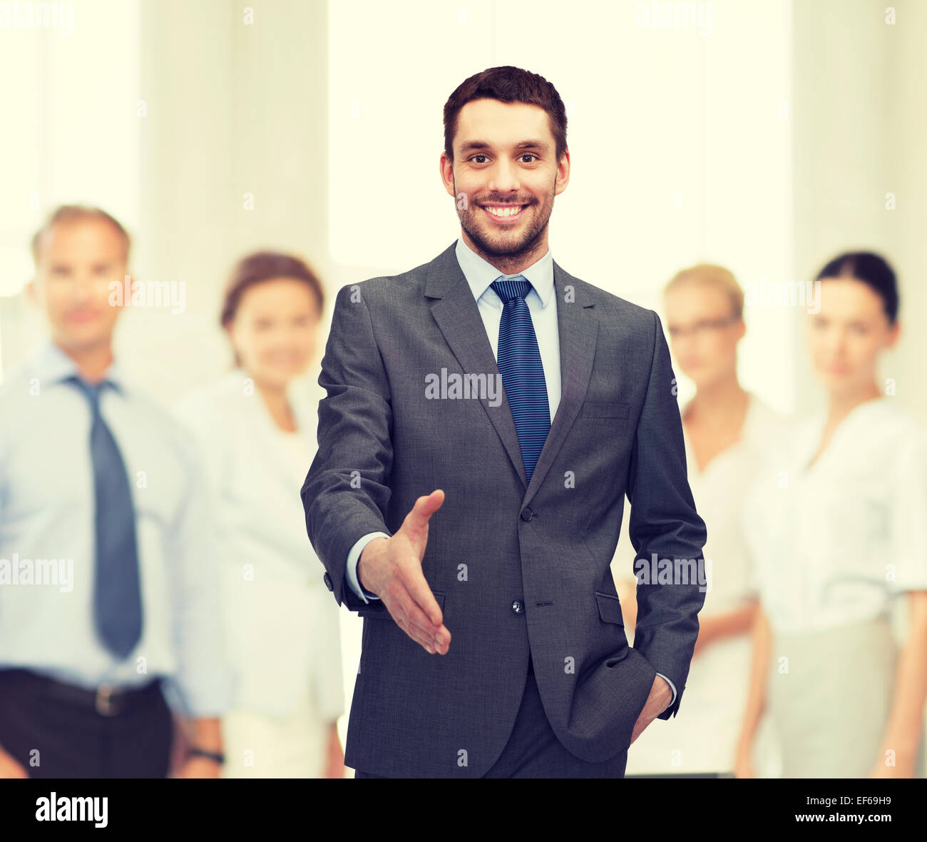 Young handsome businessman giving handshake hi-res stock photography ...