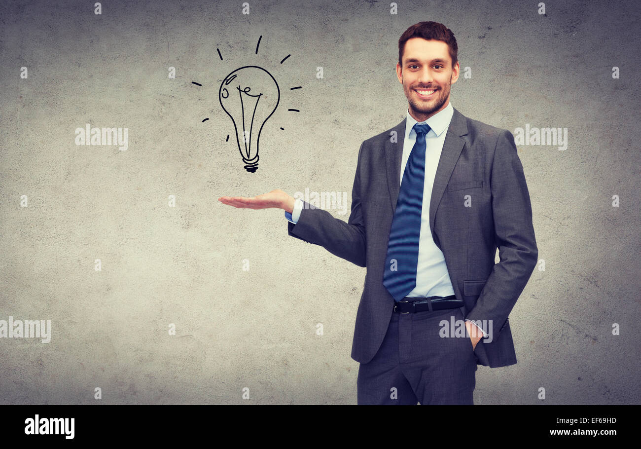 man showing light bulb on the palm of his hand Stock Photo - Alamy