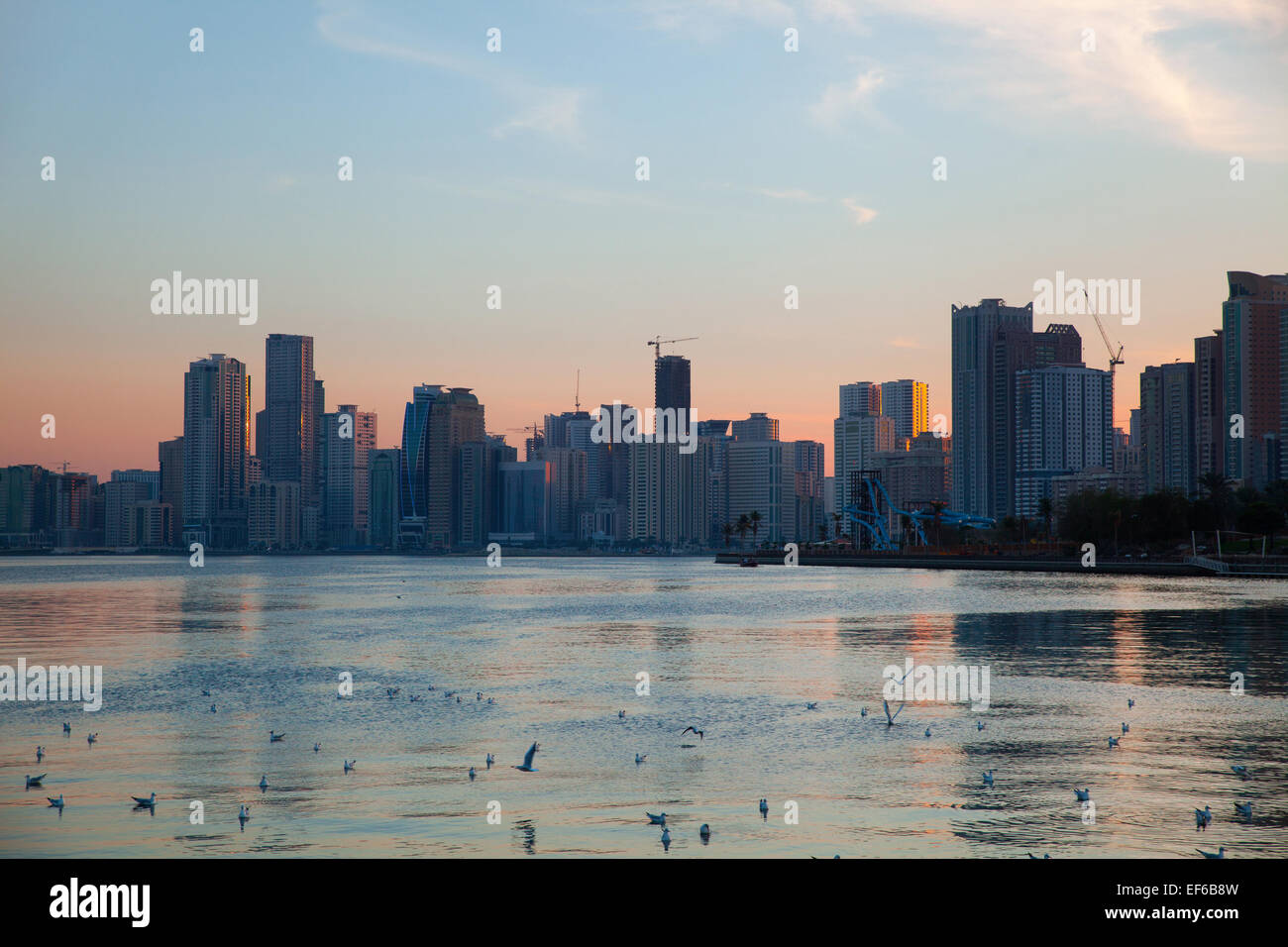 View to the modern city of Sharjah (UAE) skyline at sunset Stock Photo ...