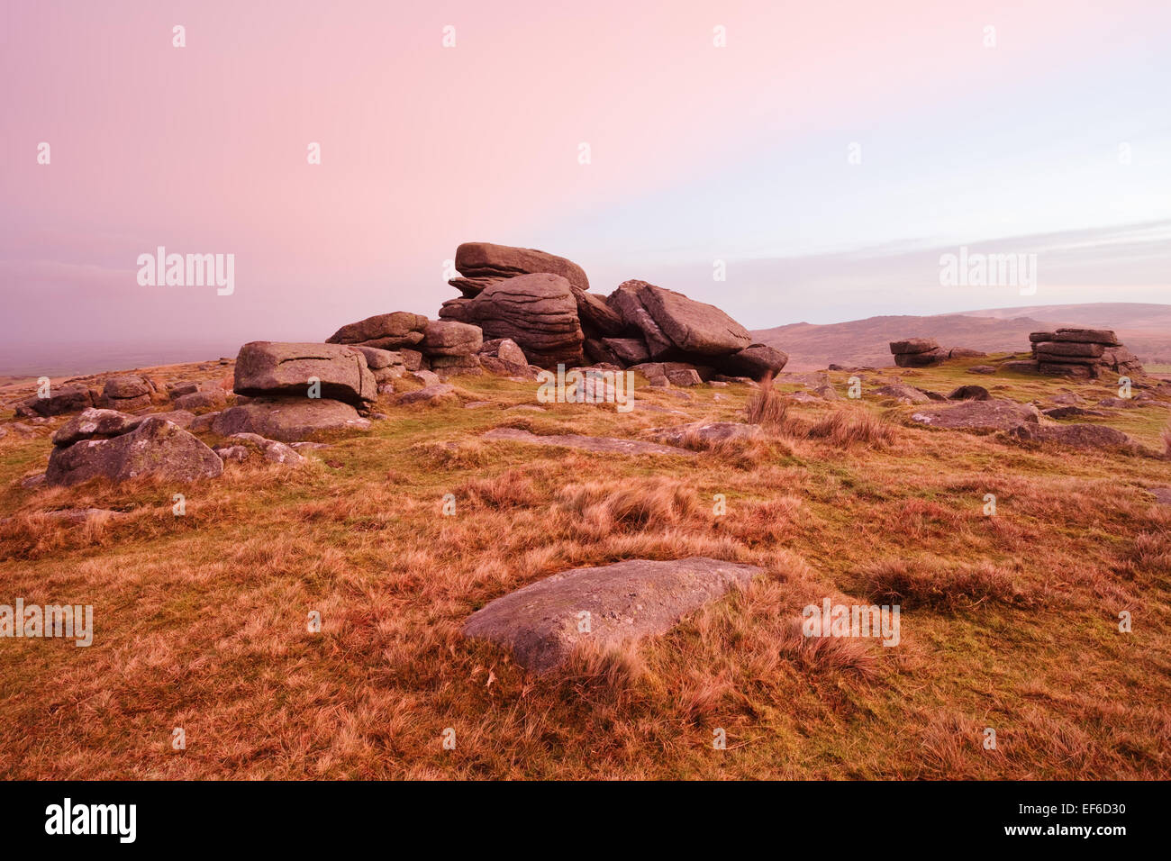 The clouds above Row tor glow pink as a sleet shower passed just before ...
