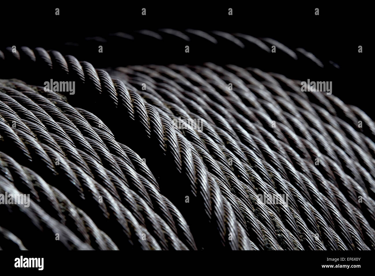 Closeup of heavy duty thick gauge steel woven cable with black ...