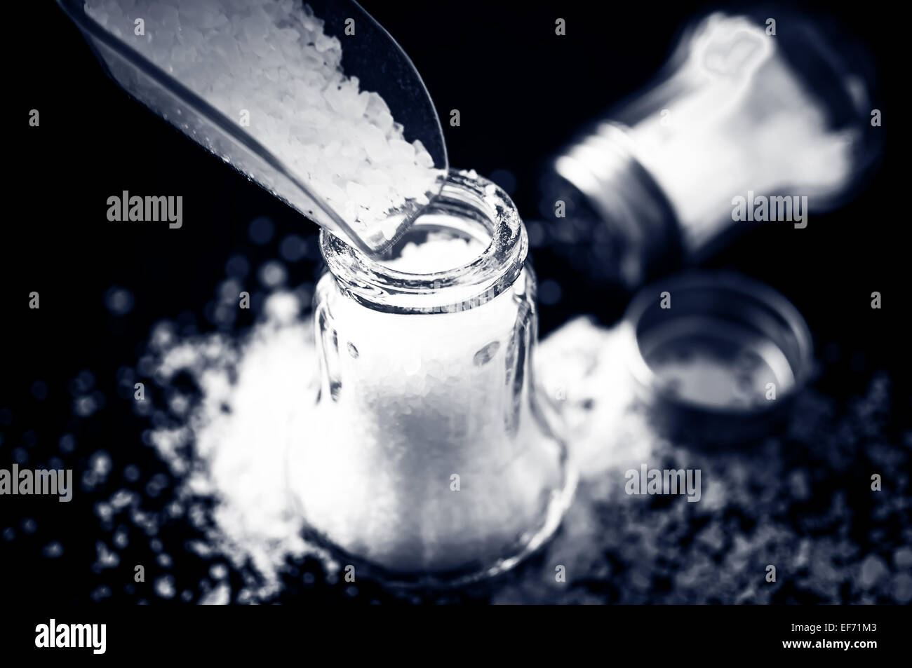 Two glass salt shakers and salt Stock Photo - Alamy
