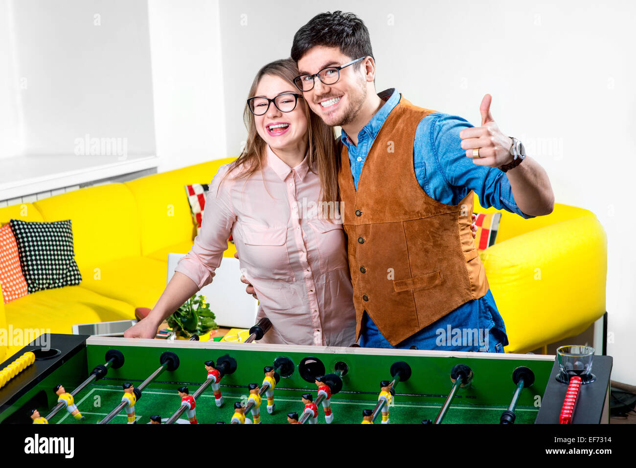 Friends playing table football Stock Photo - Alamy