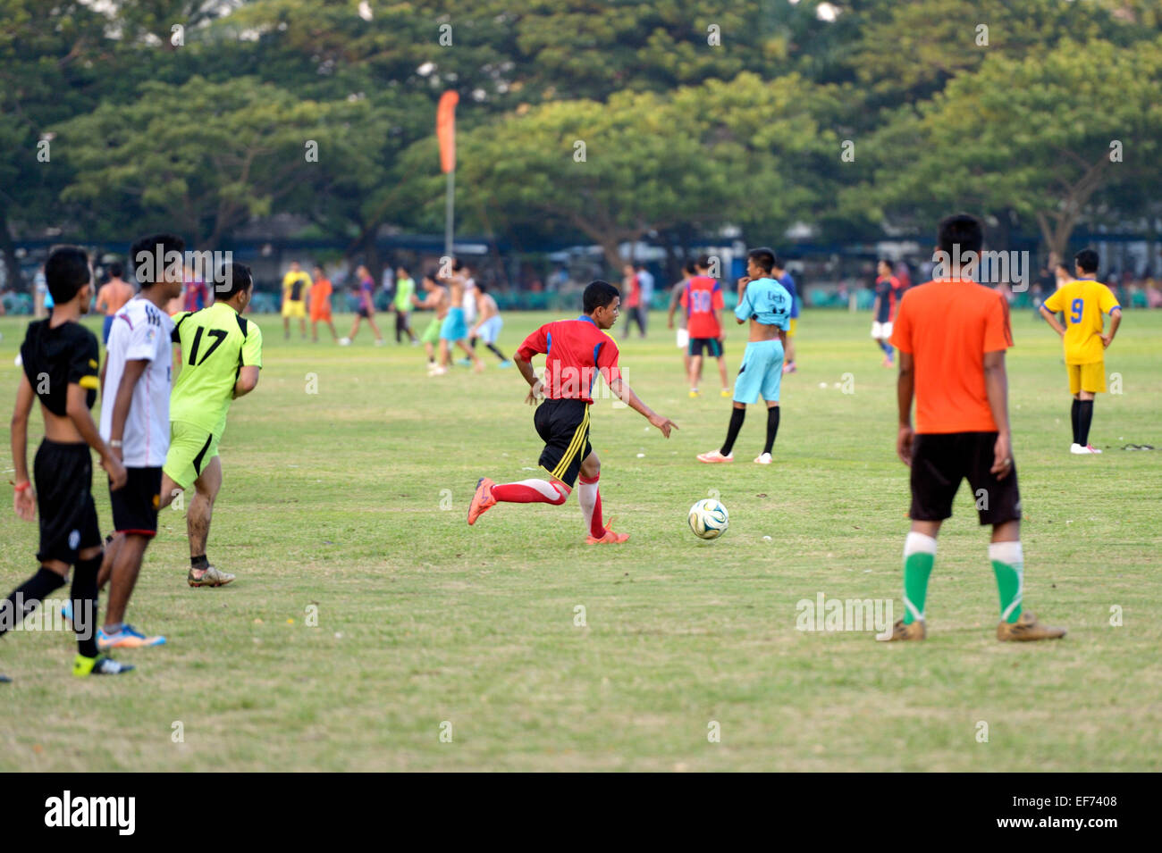 Teenagers playing football in a public park, Banda Aceh, Indonesia ...