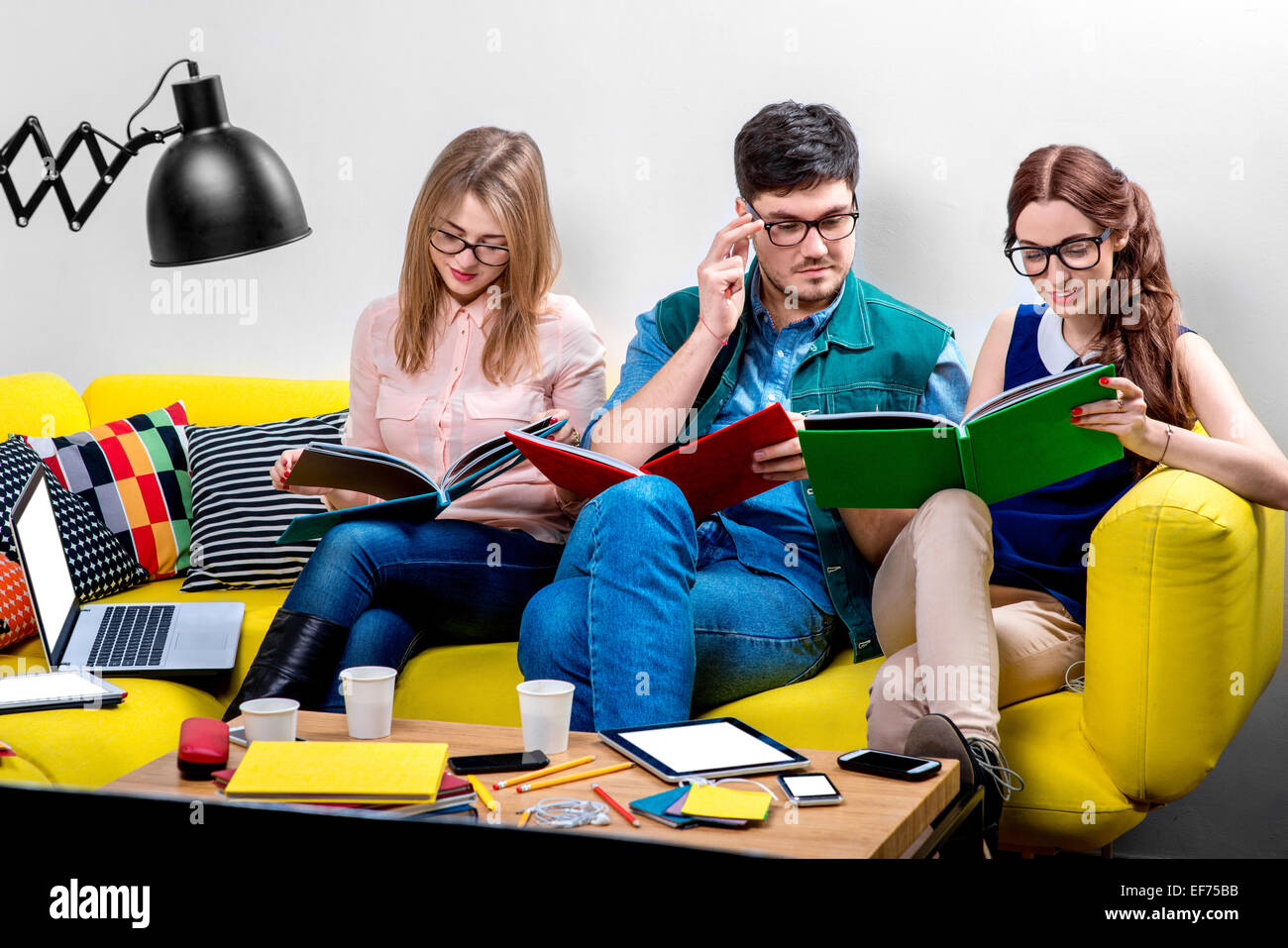 Students working on the couch Stock Photo - Alamy