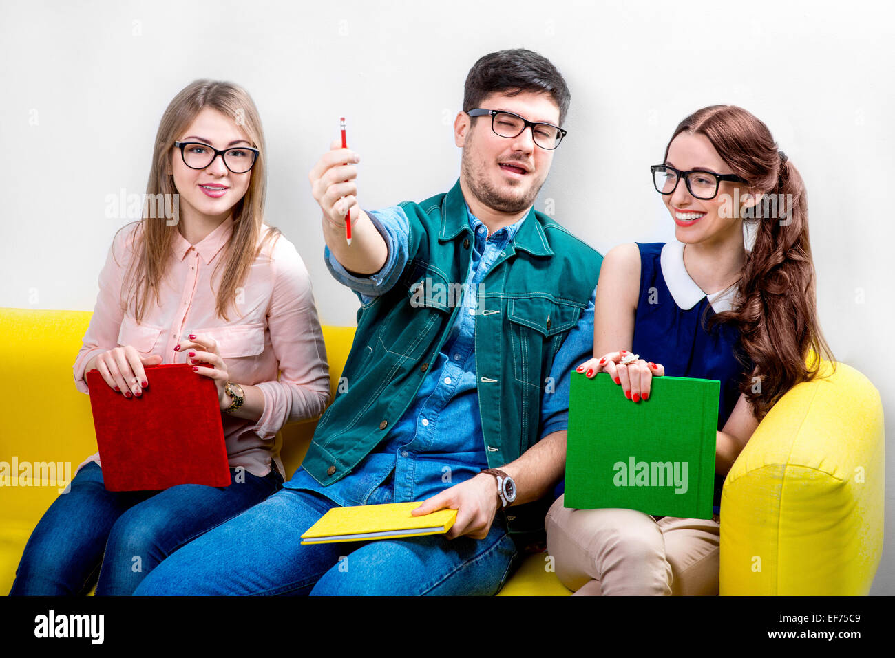 Students working on the couch Stock Photo - Alamy