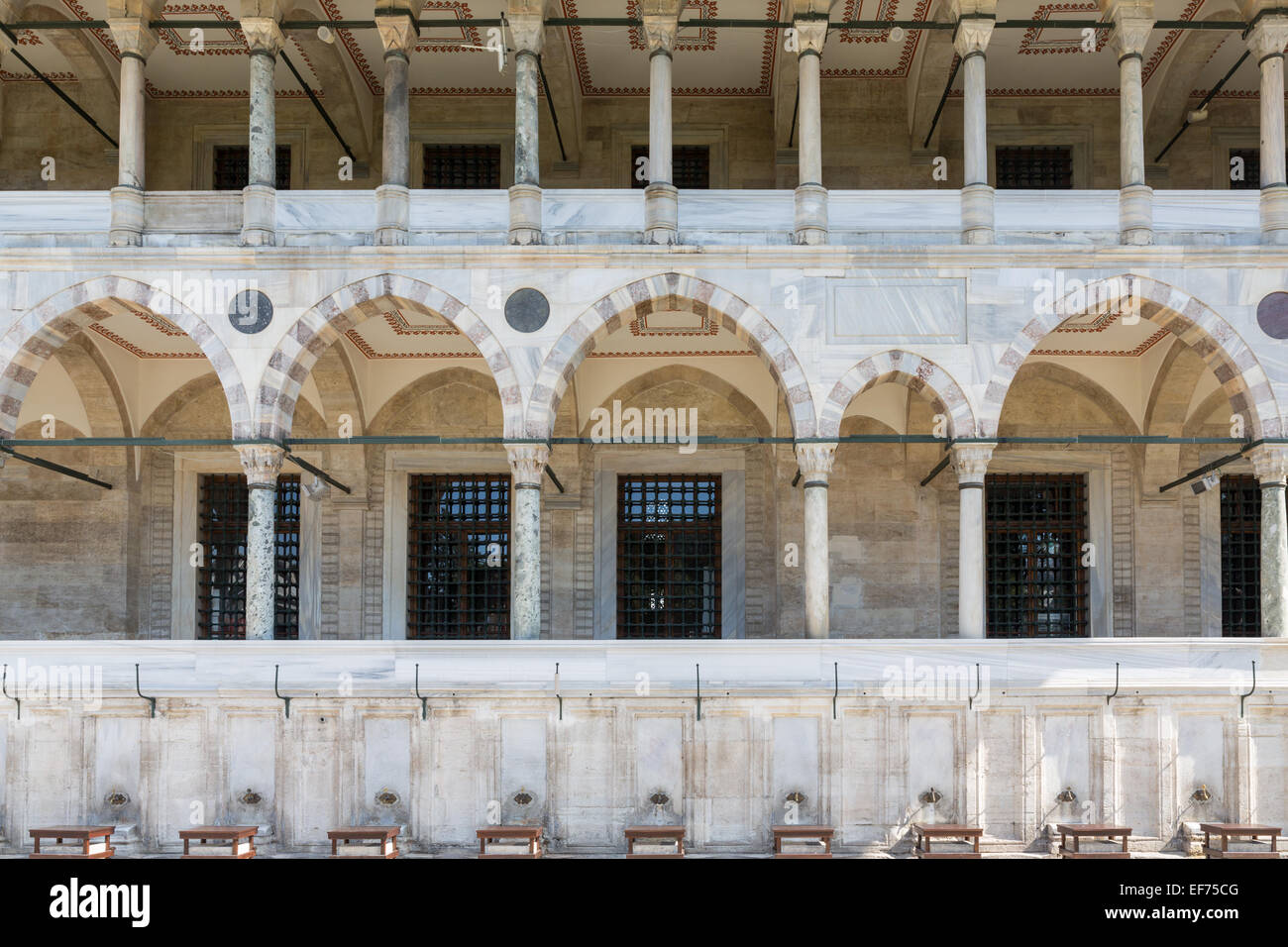 Suleymaniye mosque. Places for ritual ablution and corridor with arches ...