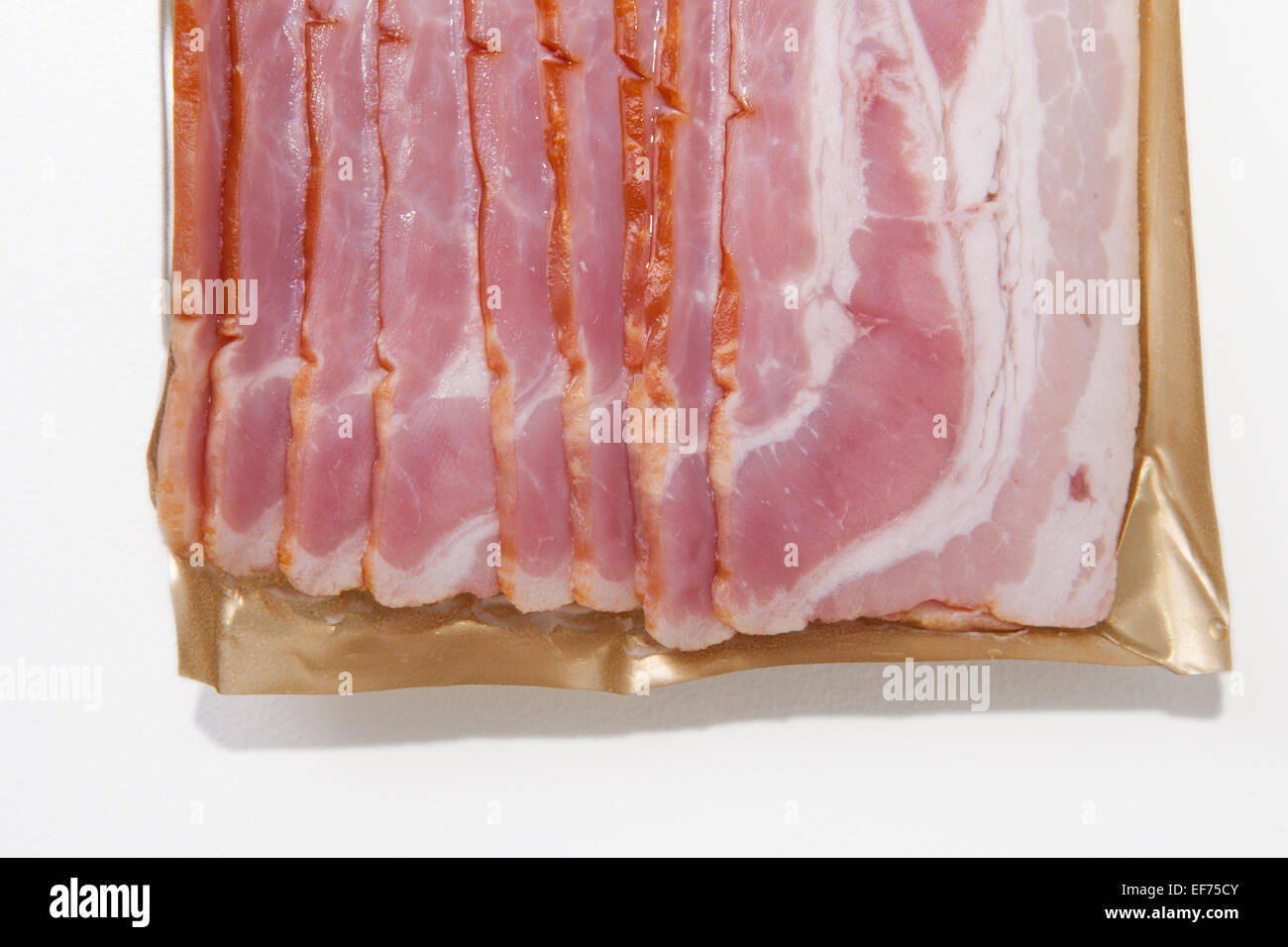 Bacon slices on the package, isolated on white background Stock Photo ...