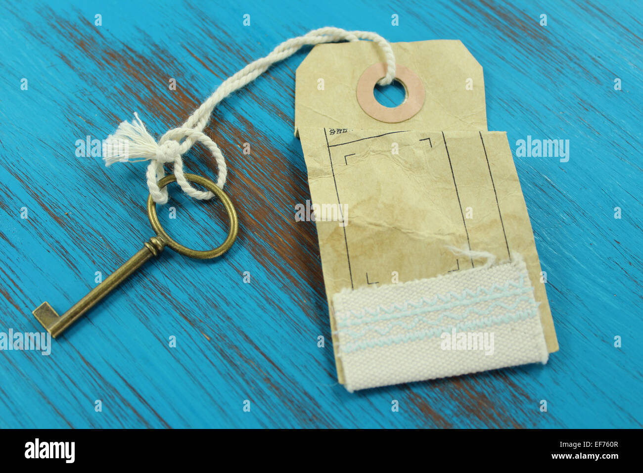 The key to success. Blue rustic wooden background. Key and tag with the ...