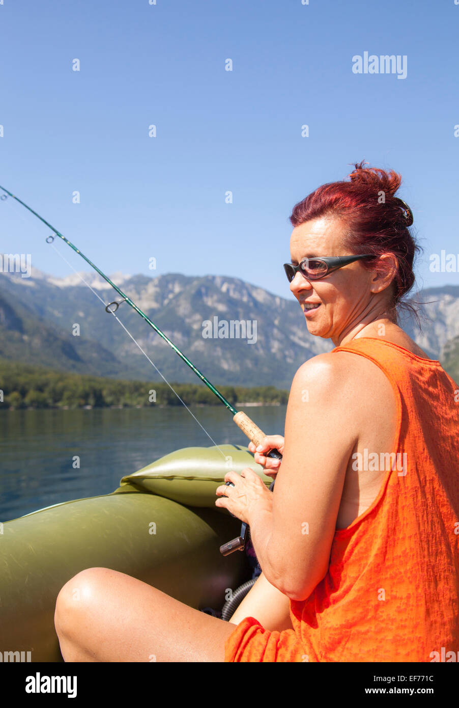 Woman fishing in beautiful hi-res stock photography and images - Alamy