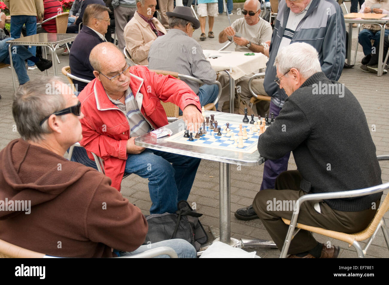 old men playing chess in a spainsh town square spain retirement retired ...