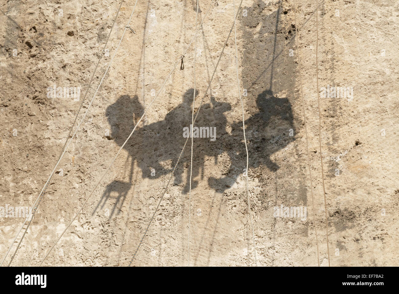 Human shadows on the bright yellow rock Stock Photo - Alamy