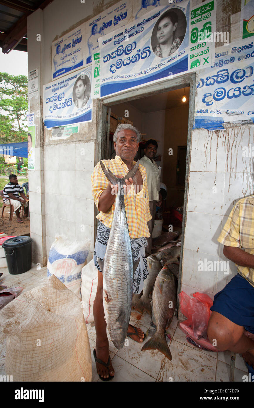 FISHERMAN SHOWING OFF CATCH OF THE DAY AT FISH MARKET Stock Photo - Alamy