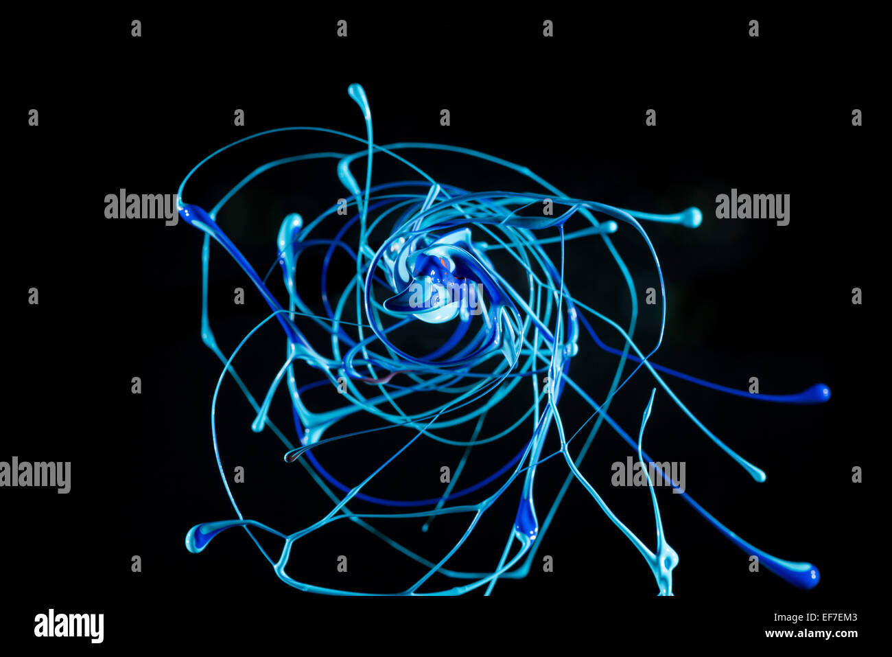 high speed spinning streaming trails of color liquid make spiral shape ...