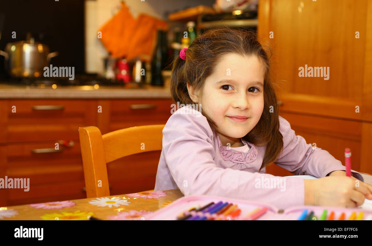 pretty smiling girl writes on her notebook Stock Photo - Alamy