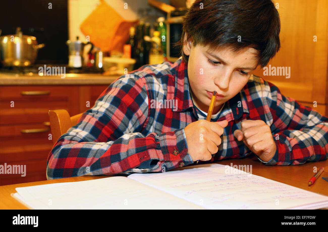 thoughtful guy makes the homework at his home Stock Photo - Alamy