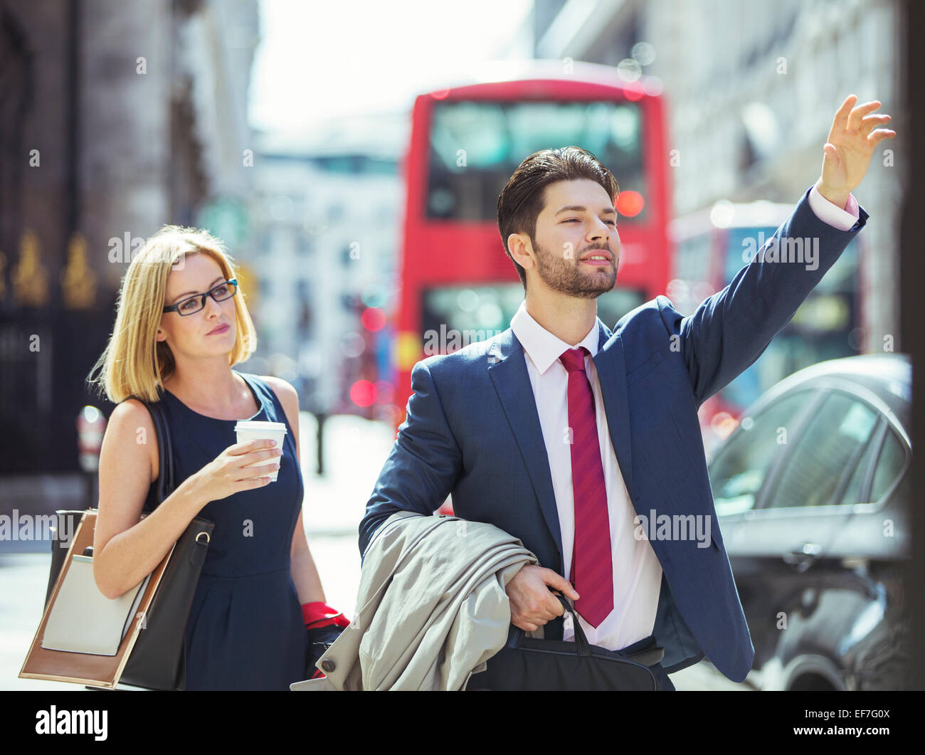 Business people hailing taxi in city Stock Photo - Alamy