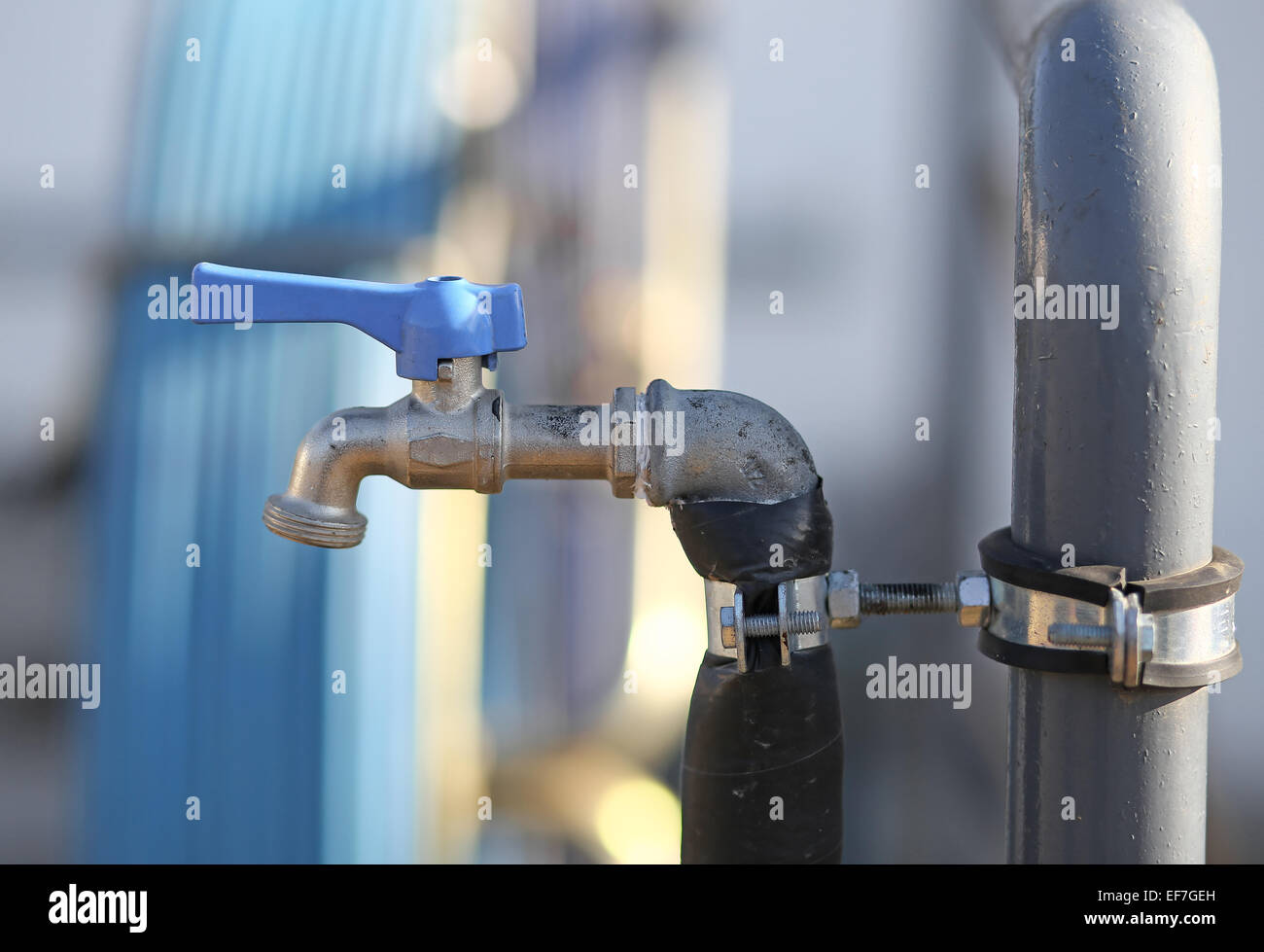 blue water tap to irrigate the garden home in summer Stock Photo - Alamy