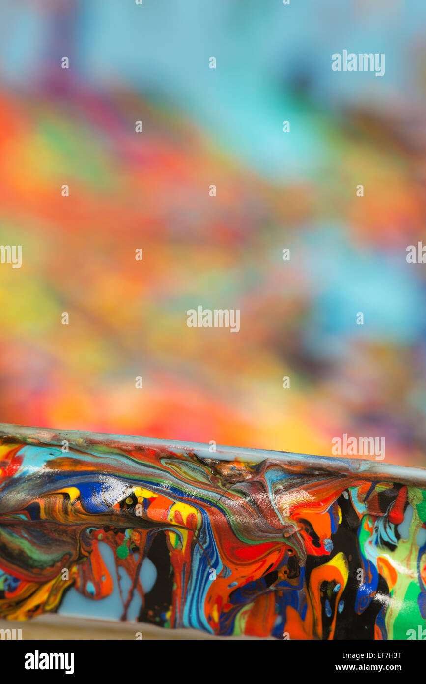 splattered colored paint creating abstract colorful drops of swirling ...