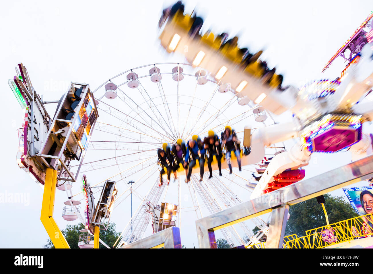 People enjoying fairground rides at Goose Fair, Nottingham, England, UK ...