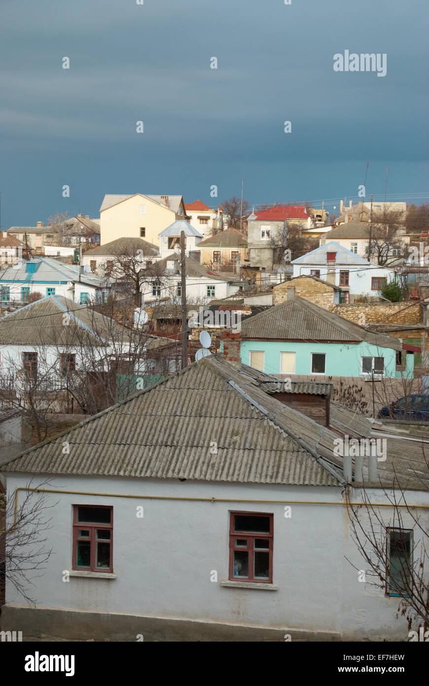 Many rural houses with dark storm clouds Stock Photo - Alamy