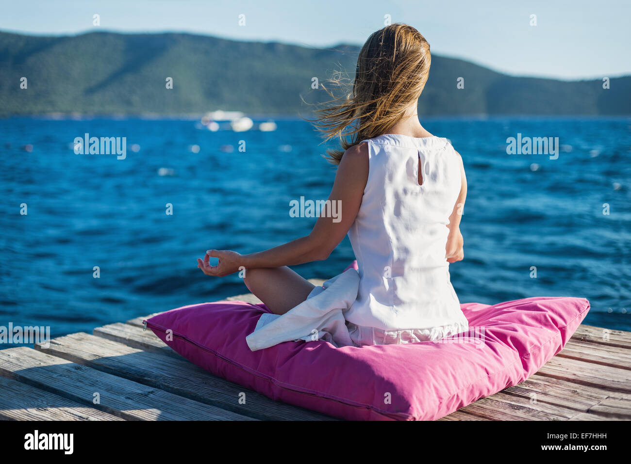 Woman meditating at the sea Stock Photo - Alamy