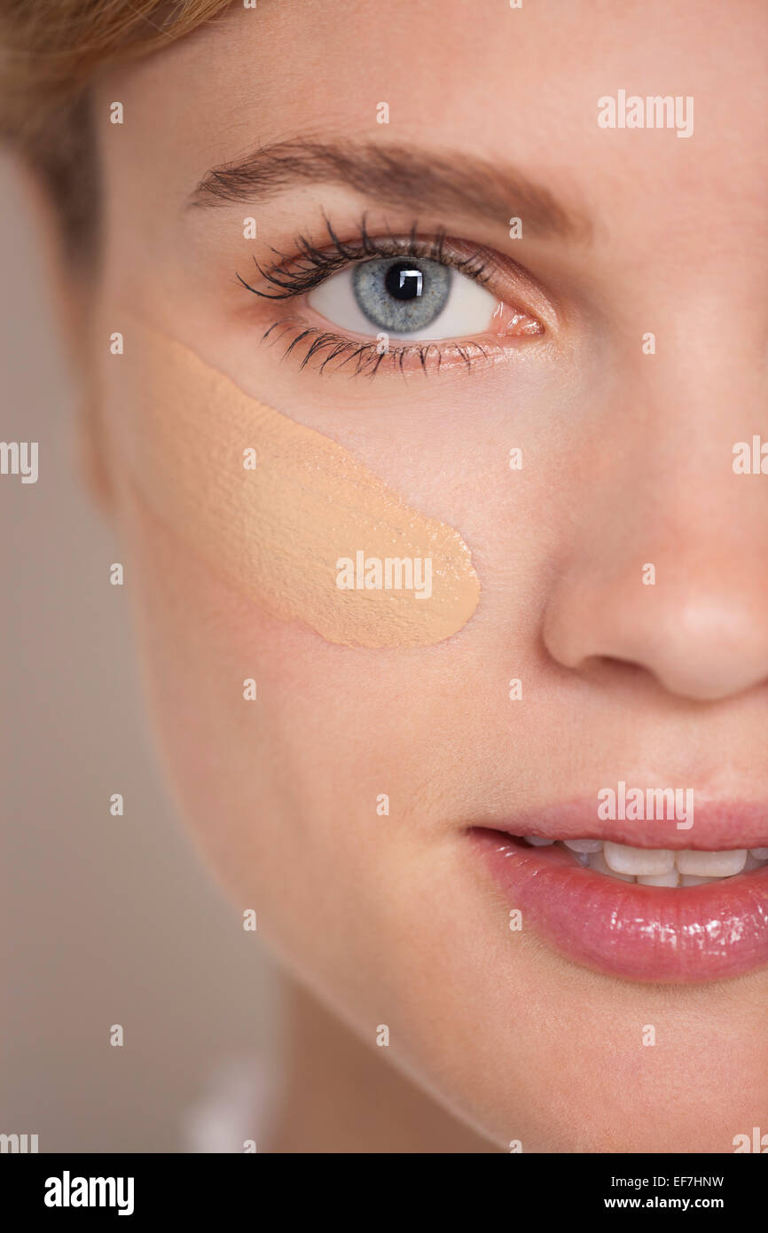 Woman applying foundation to her face hi-res stock photography and ...