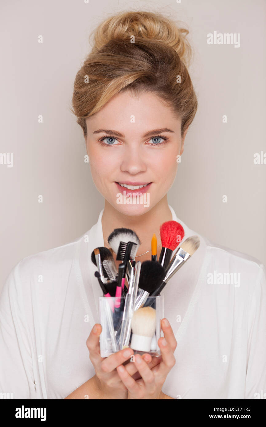 beautiful woman with makeup brush Stock Photo - Alamy