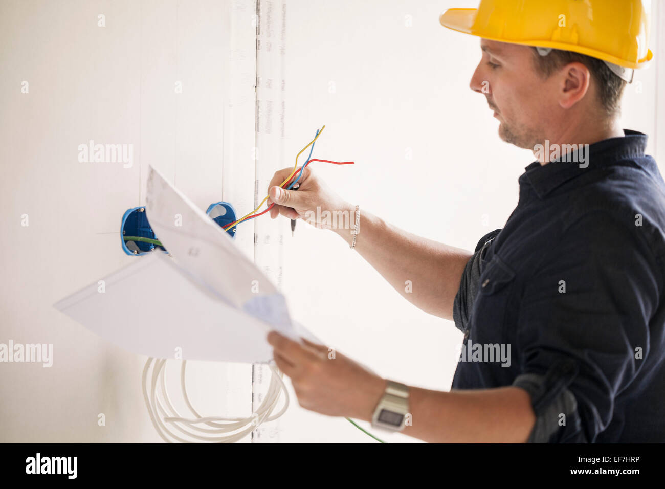 Electrician working at site Stock Photo - Alamy