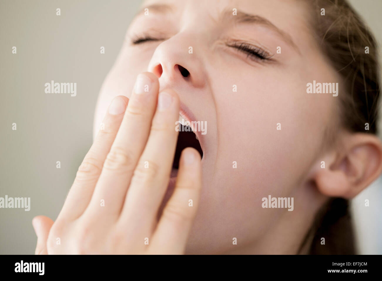 Close-up of a girl yawning Stock Photo - Alamy