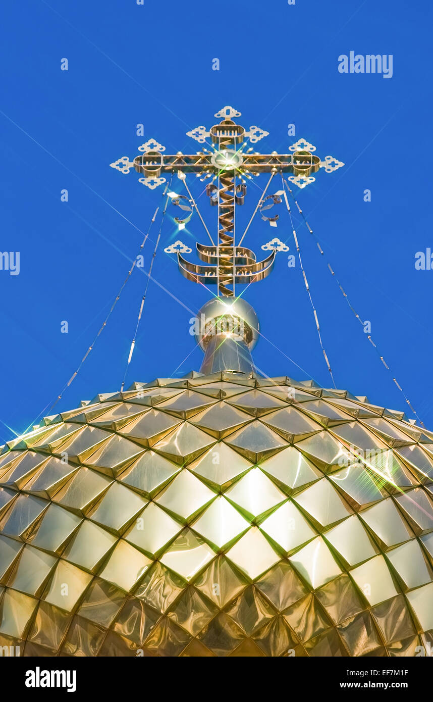 Golden orthodox cross against blue sky background Stock Photo - Alamy
