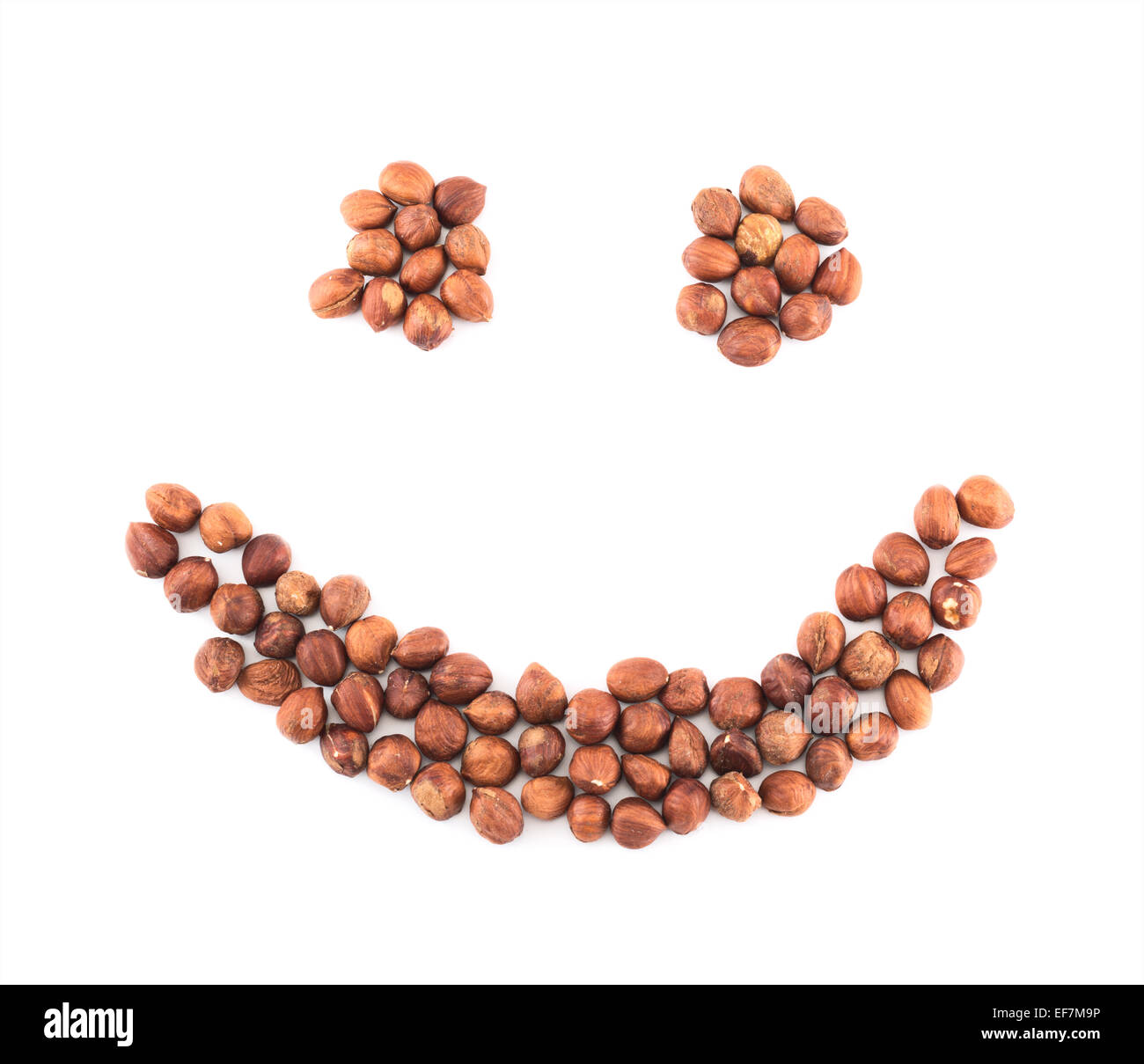 Smile shape made of hazelnuts isolated Stock Photo - Alamy