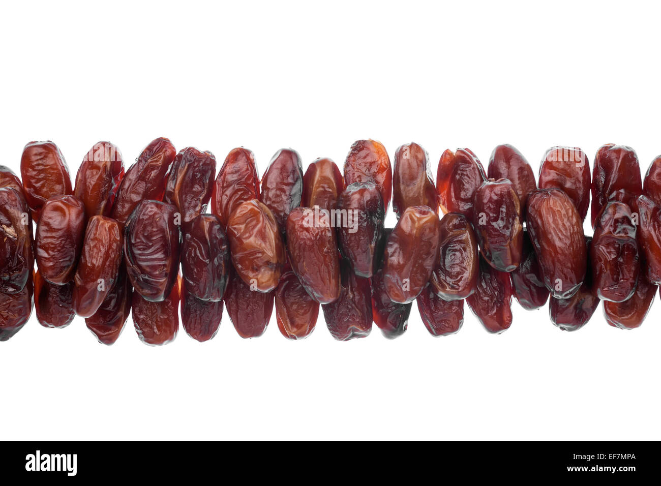 line of dried dates, isolated on white background Stock Photo - Alamy