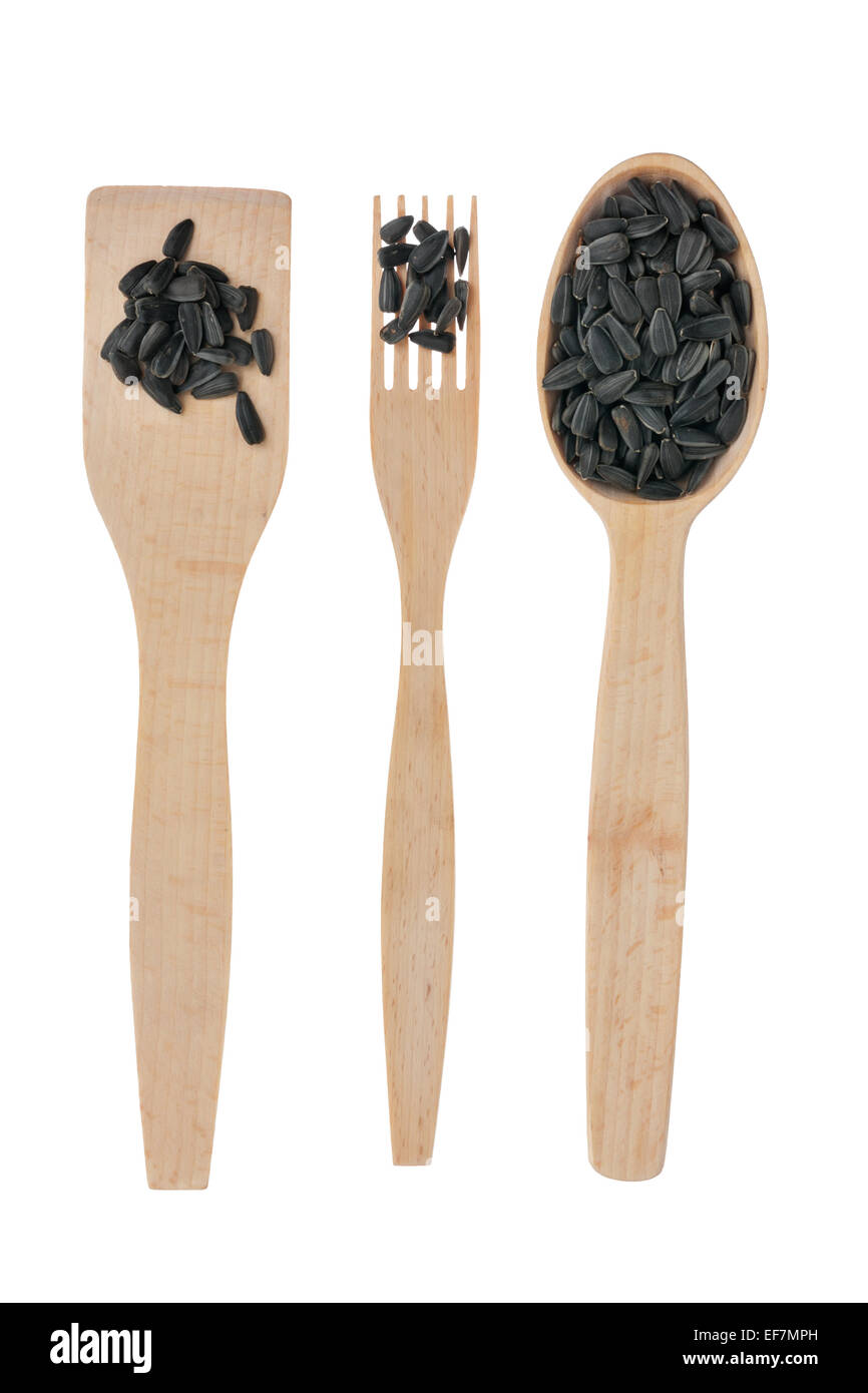 Wooden spoon, fork, paddle with sunflower seed, isolated on white ...
