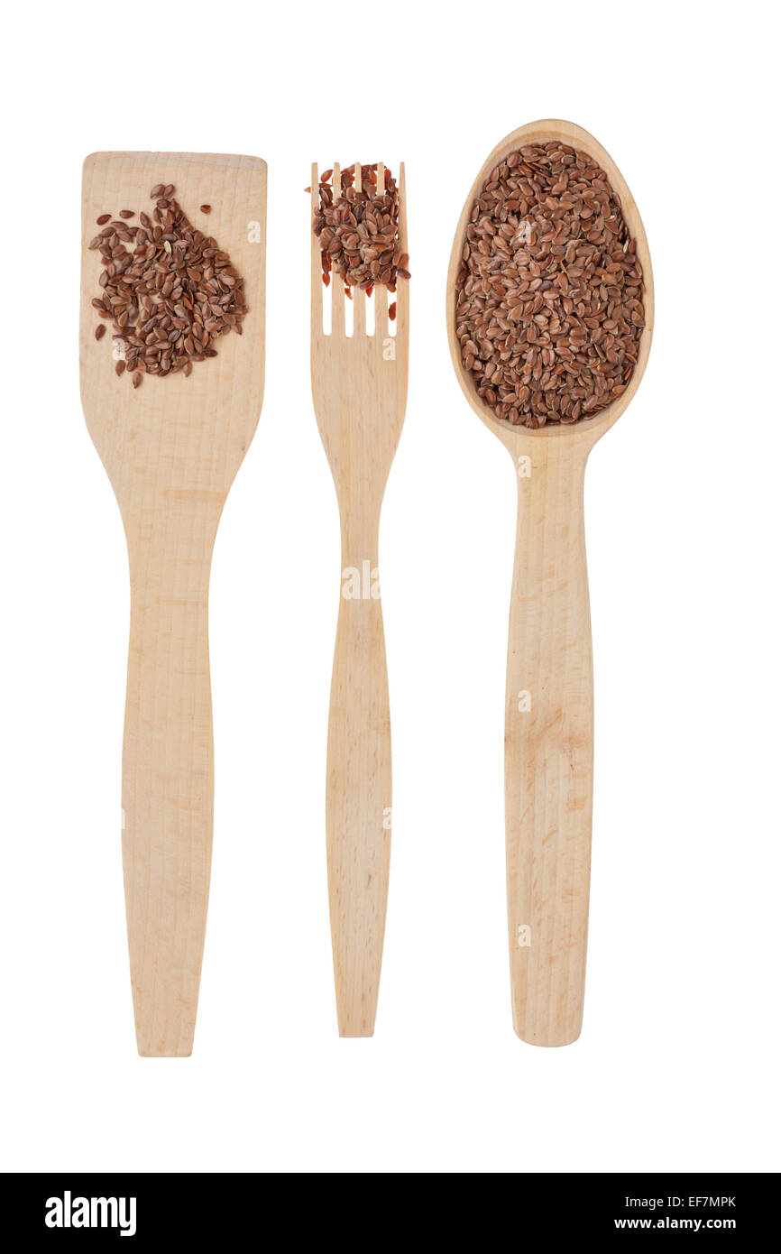 Wooden spoon, fork, paddle with flax seed, isolated on white background ...