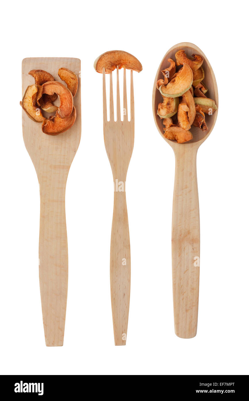 Wooden spoon, fork, paddle with dried apple, isolated on white ...