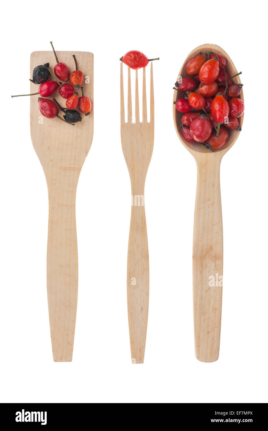 Wooden spoon, fork, paddle with rosehips, isolated on white background ...