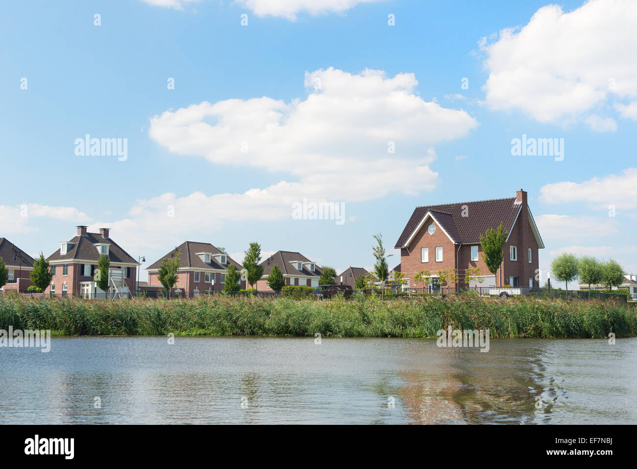 Modern new houses near the river Stock Photo - Alamy
