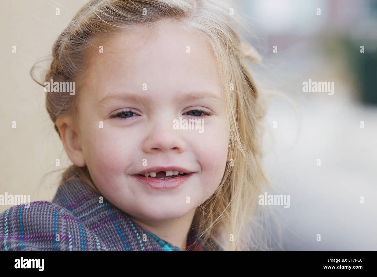 Smiling blonde girl with a missing tooth Stock Photo - Alamy