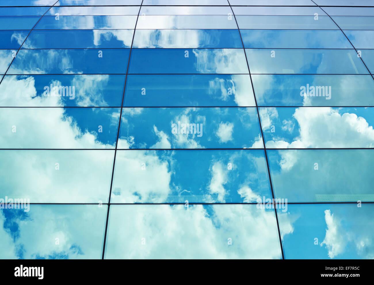 Cloudy sky reflected in the windows of skyscraper urban background hi ...