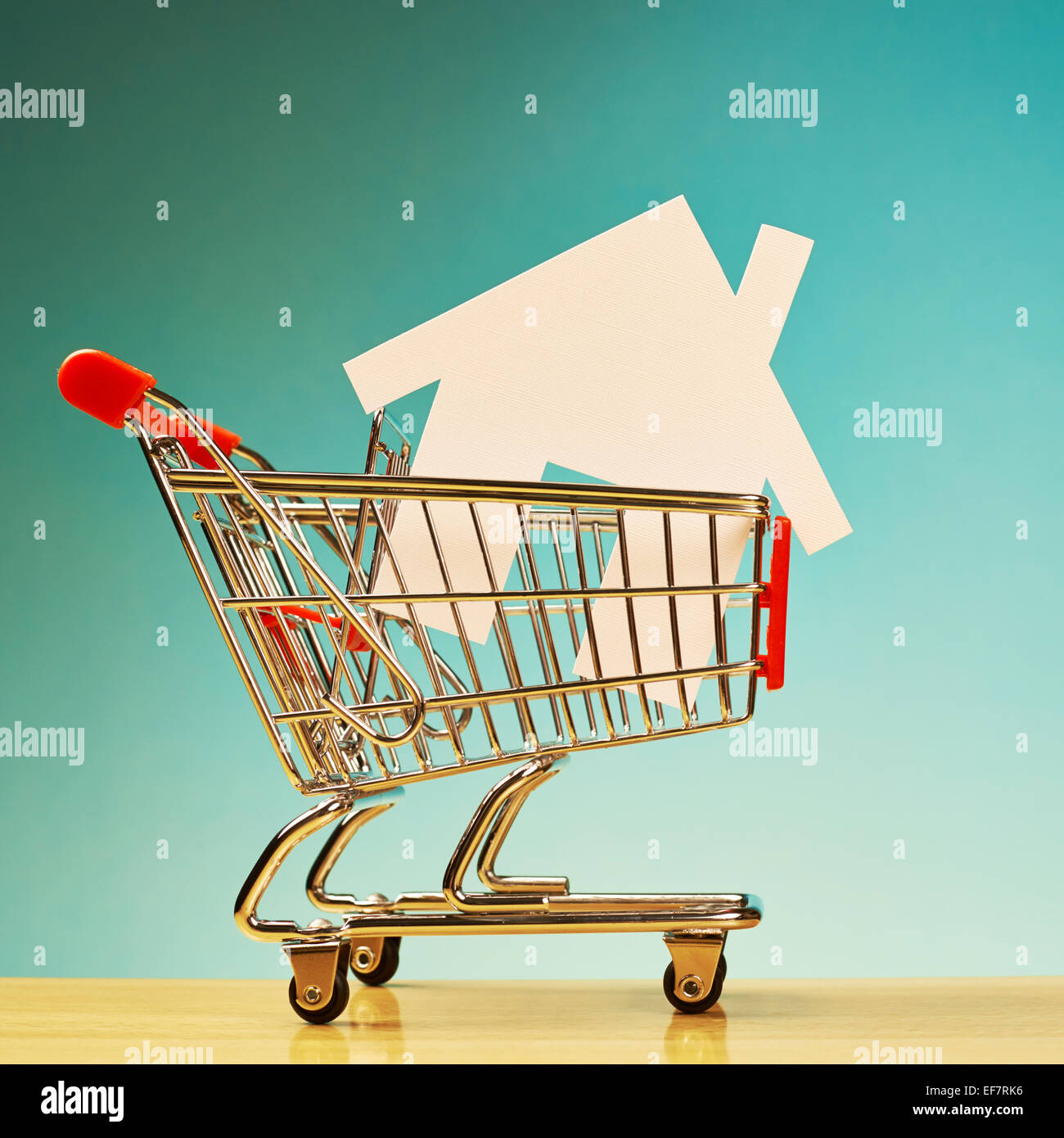 House shape inside shopping cart Stock Photo - Alamy