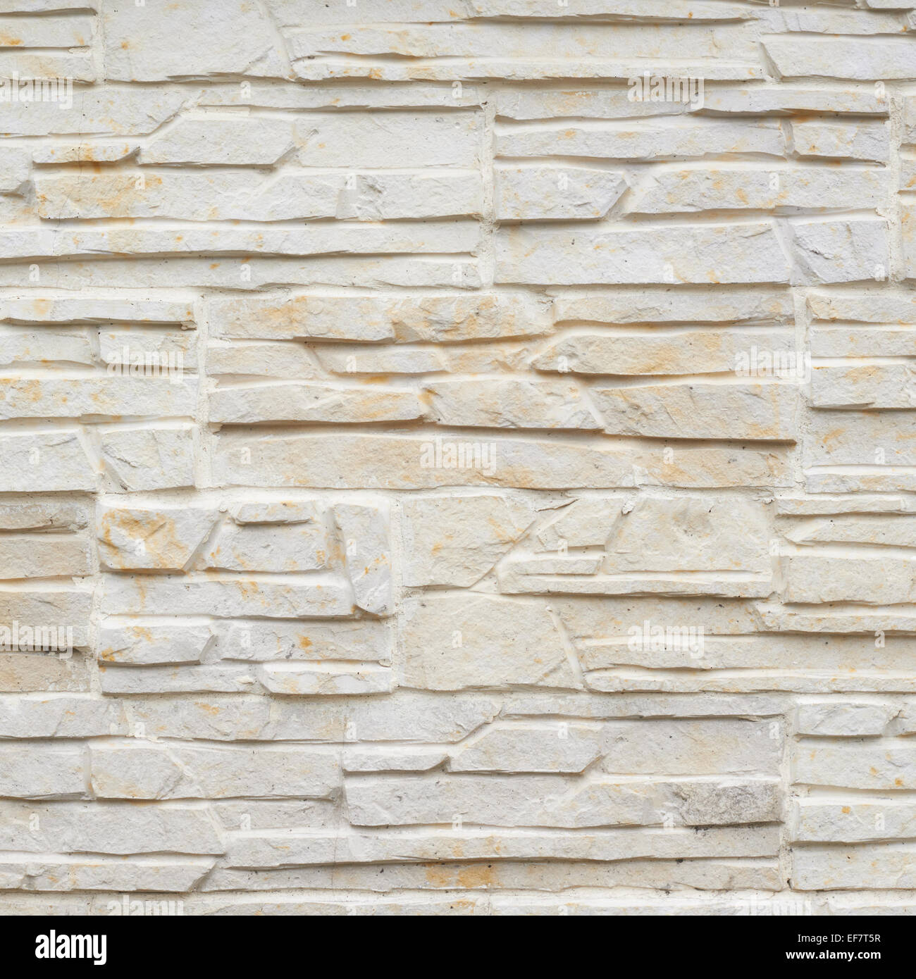 Wall of carved limestone bricks Stock Photo - Alamy
