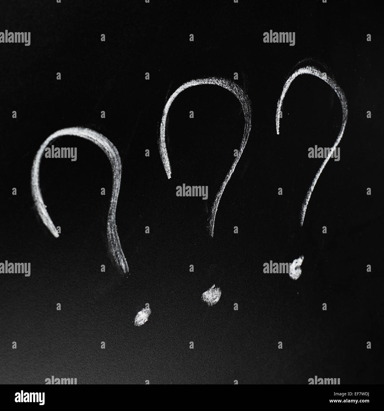 Three question marks on the blackboard Stock Photo - Alamy