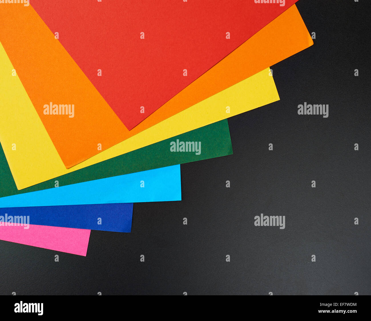 Colorful sheets over the black surface Stock Photo - Alamy