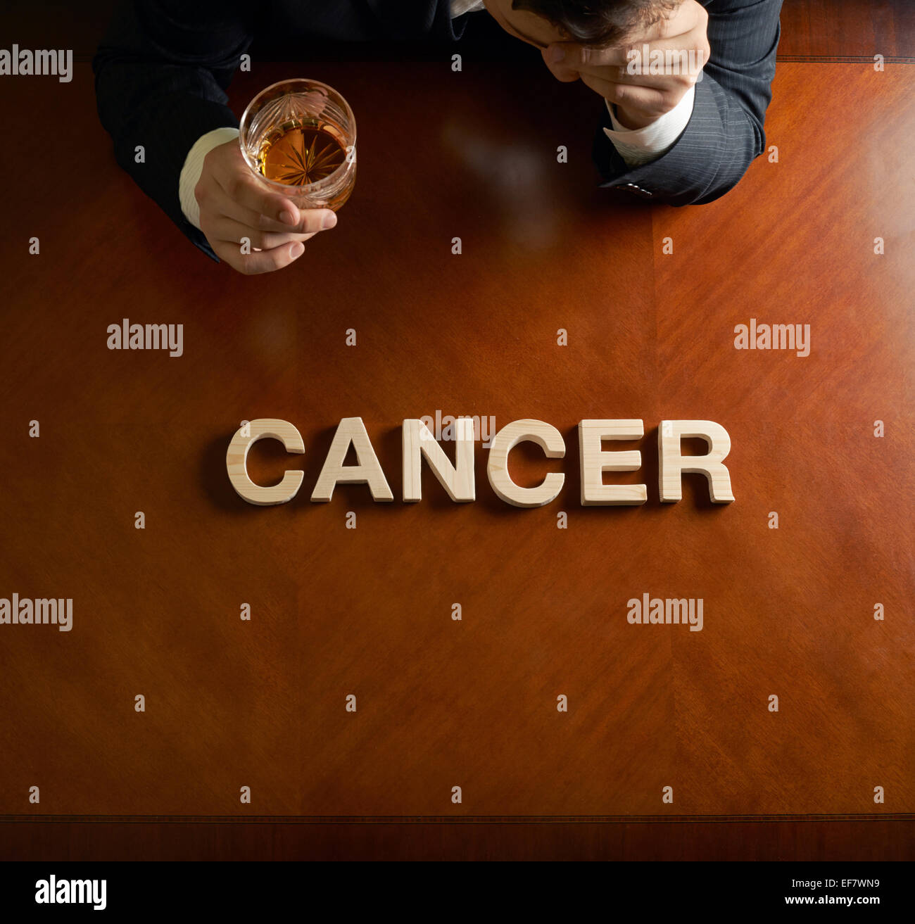 Word Cancer and devastated man composition Stock Photo - Alamy