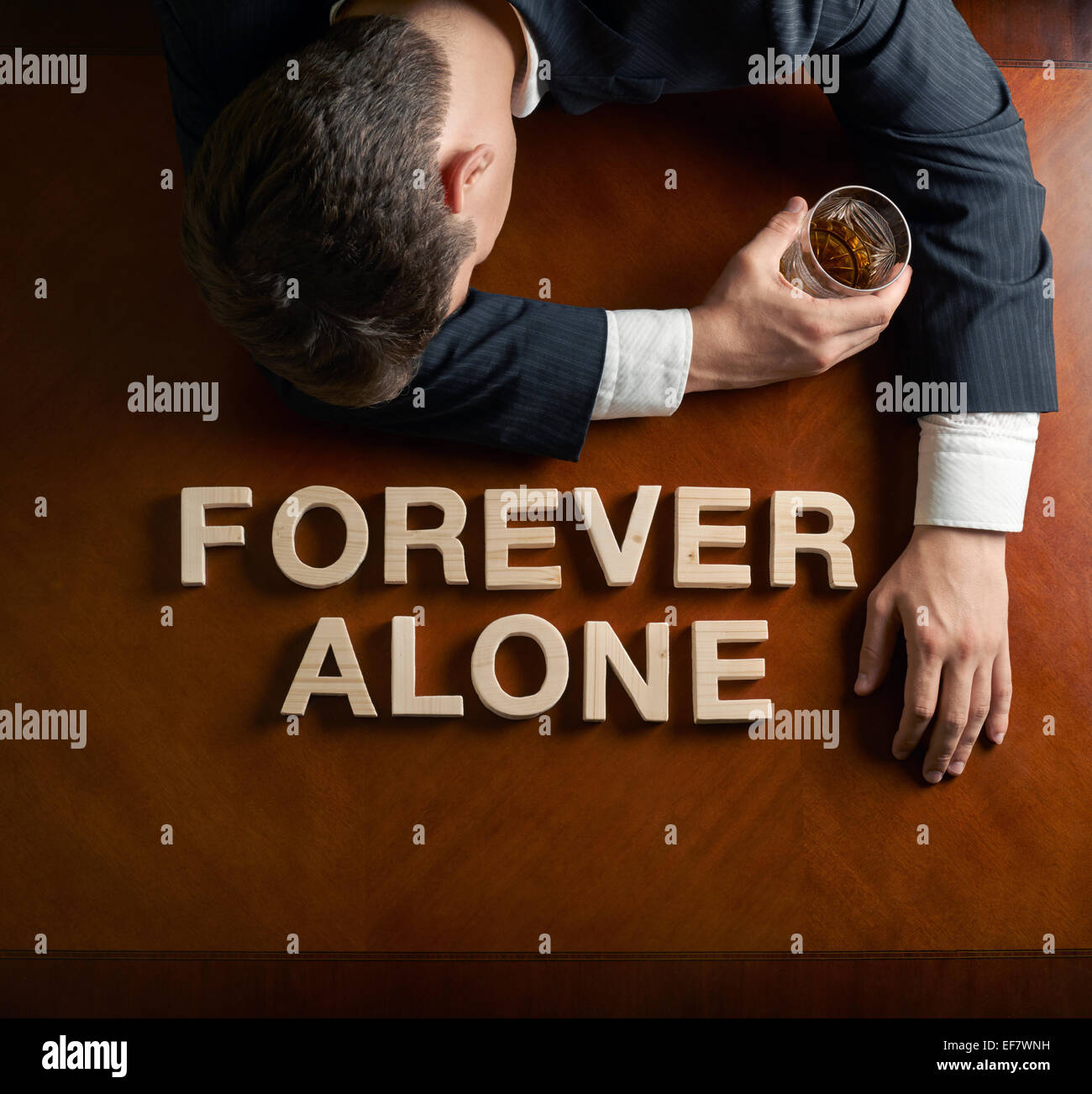 Phrase Forever Alone and devastated man composition Stock Photo - Alamy