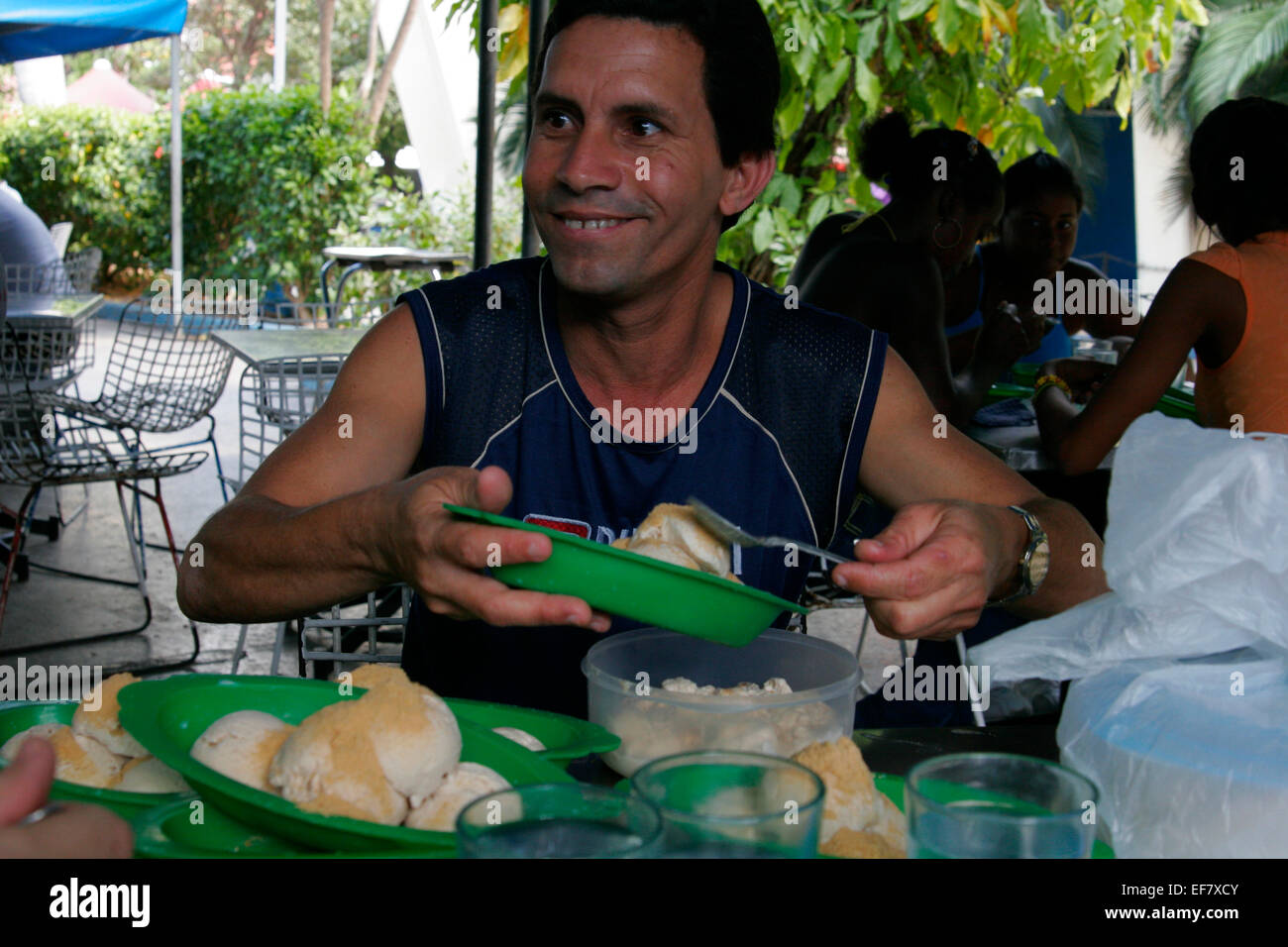Cuban man smiling and eating ice cream at the famous Coppelia cafe ...