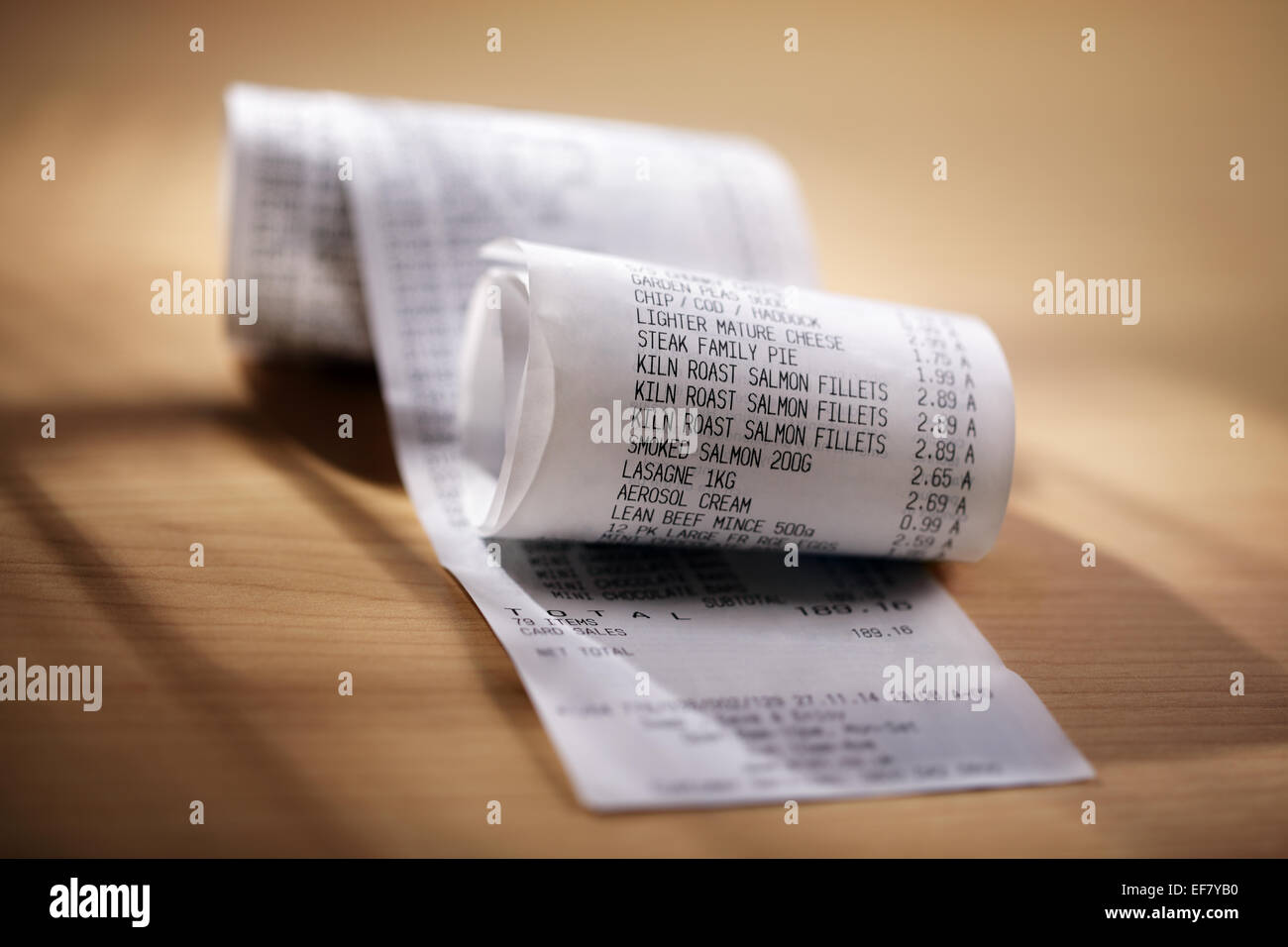 Grocery shopping list till roll printout on a wooden table Stock Photo ...