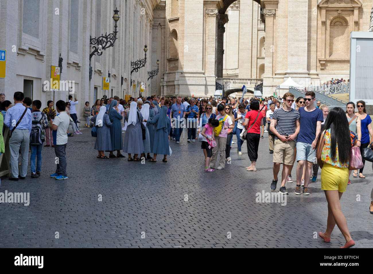 A crowd of tourist gathered outside St Peter's basilica, Vatican City ...